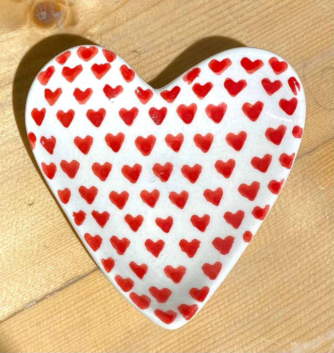 Small heart platter with little red hearts. Size is 3” in length ...